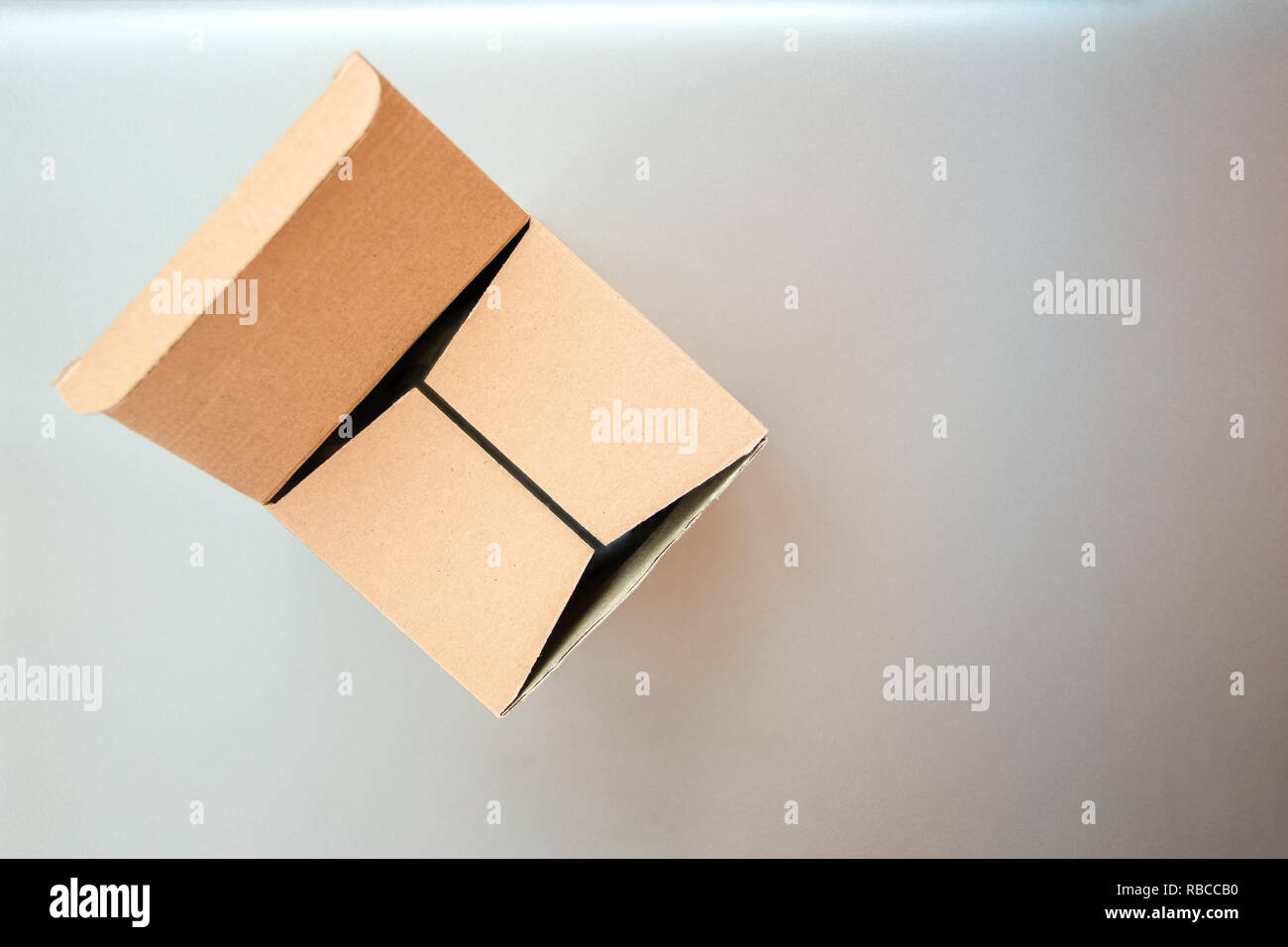 Half closed, half opened big square cardboard craft gift box on the ...