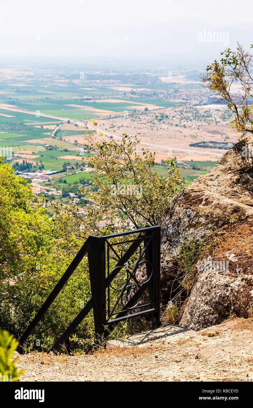 Black metal gate, railings and stairs down the hill from Meteora rock ...