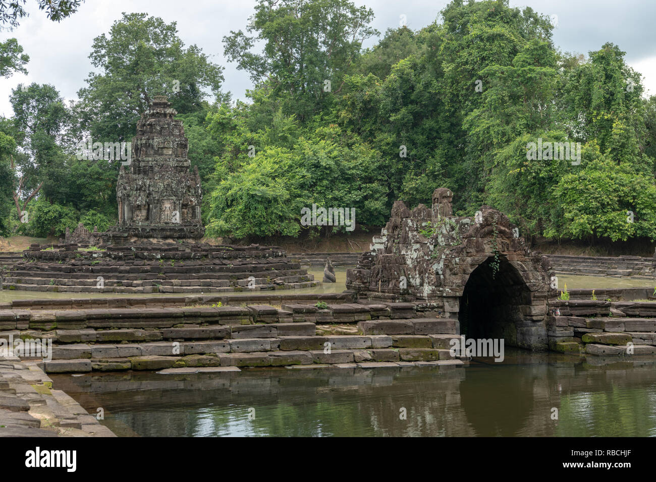 Decorative stone monuments in ponds with trees Stock Photo - Alamy
