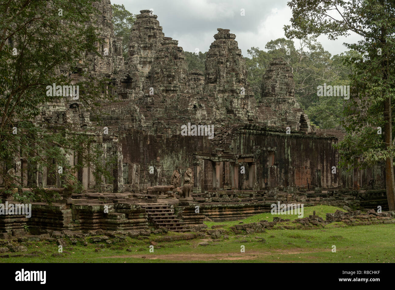Facade of Bayon temple surrounded by trees Stock Photo - Alamy