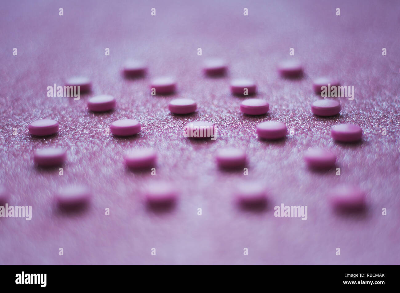 Pink pills, medicine isolated on glittery pink background Stock Photo ...