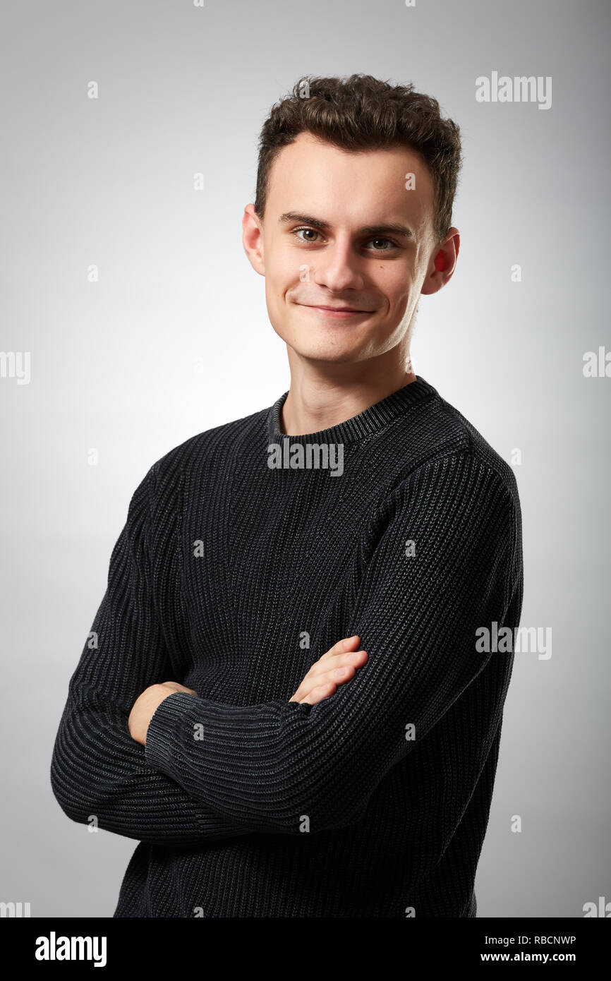Young man with arms folded, closeup studio shot Stock Photo - Alamy