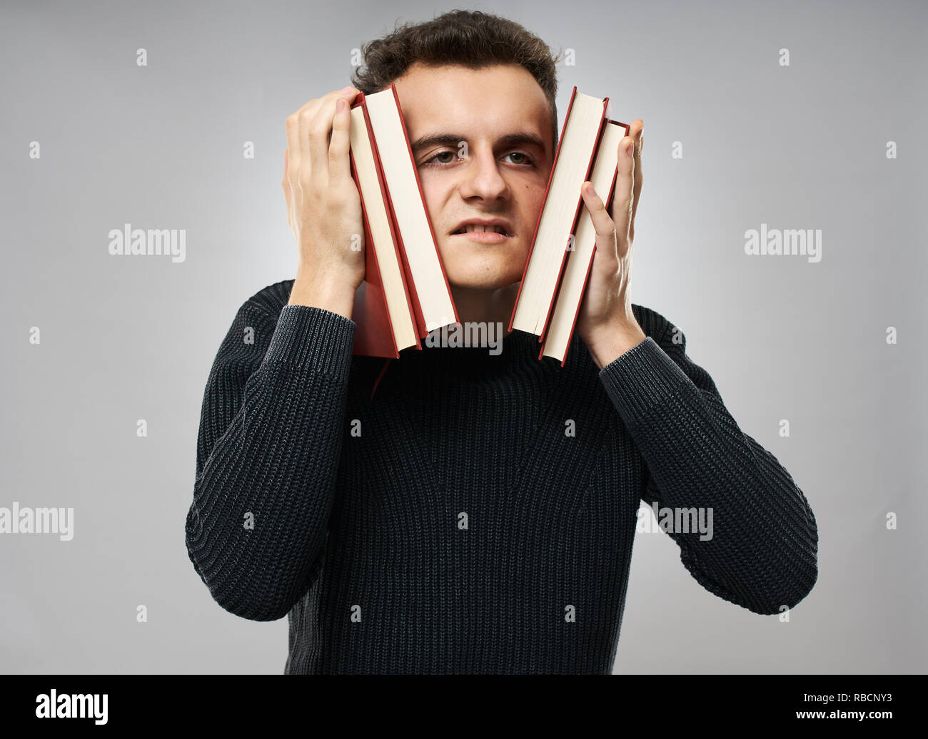 Stressed male teen with books hi-res stock photography and images - Alamy