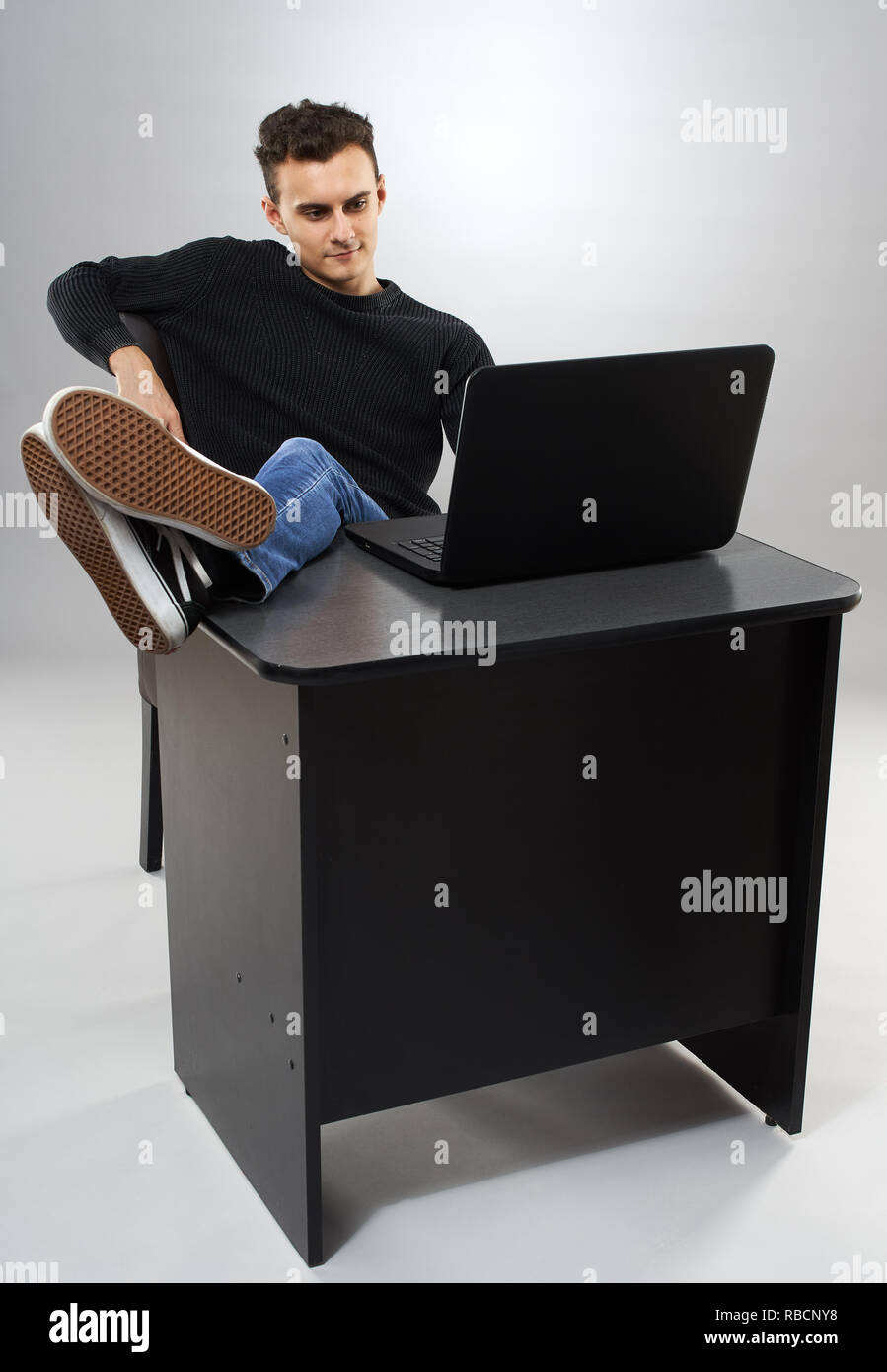 Boy sitting with feet up hi-res stock photography and images - Alamy