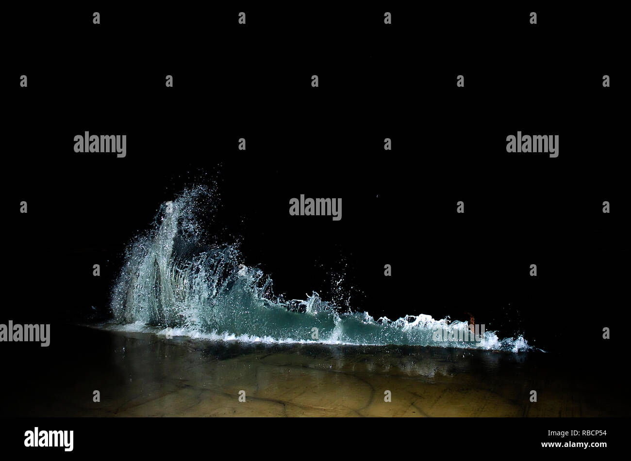 Splashing wave on the Black sea in the night Stock Photo - Alamy