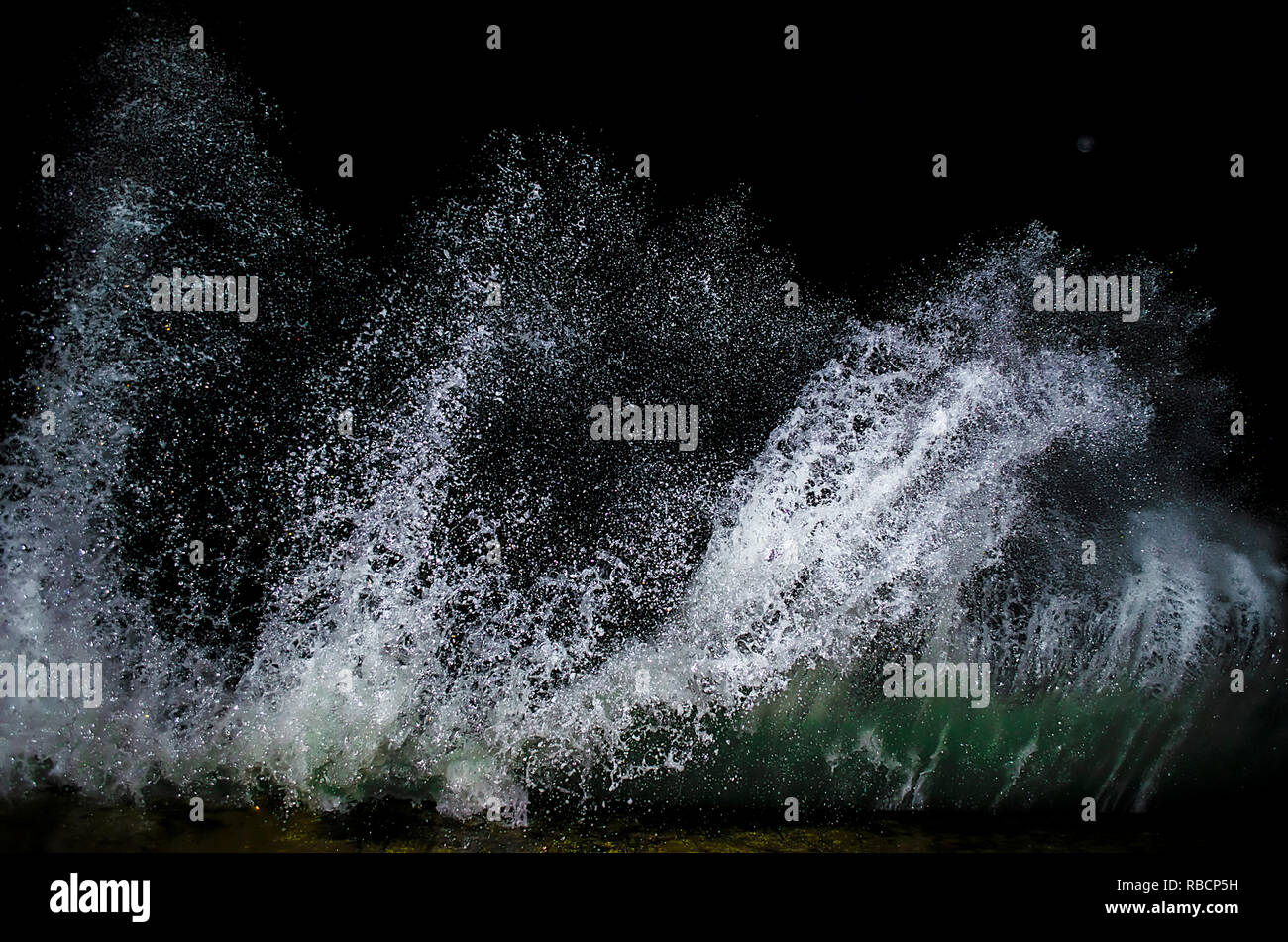 Splashing wave on the Black sea in the night Stock Photo - Alamy