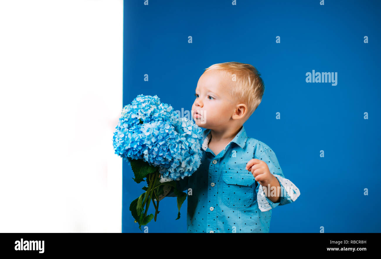 Little boy at blooming flower. Childrens day. Small baby boy. New life ...