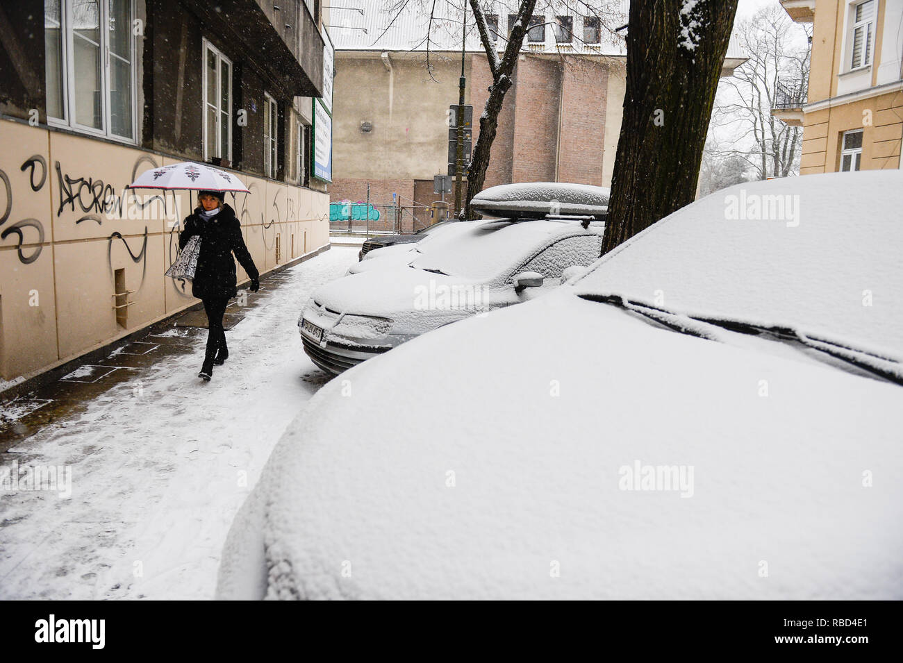 January 8, 2019 - Krakow, Poland - A woman seen walking by cars covered ...