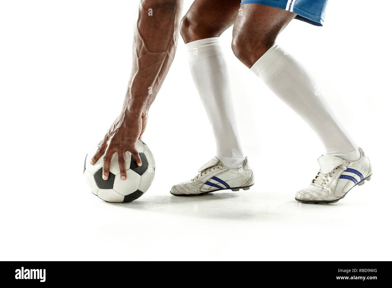 The legs of soccer player close-up isolated on white. African american ...