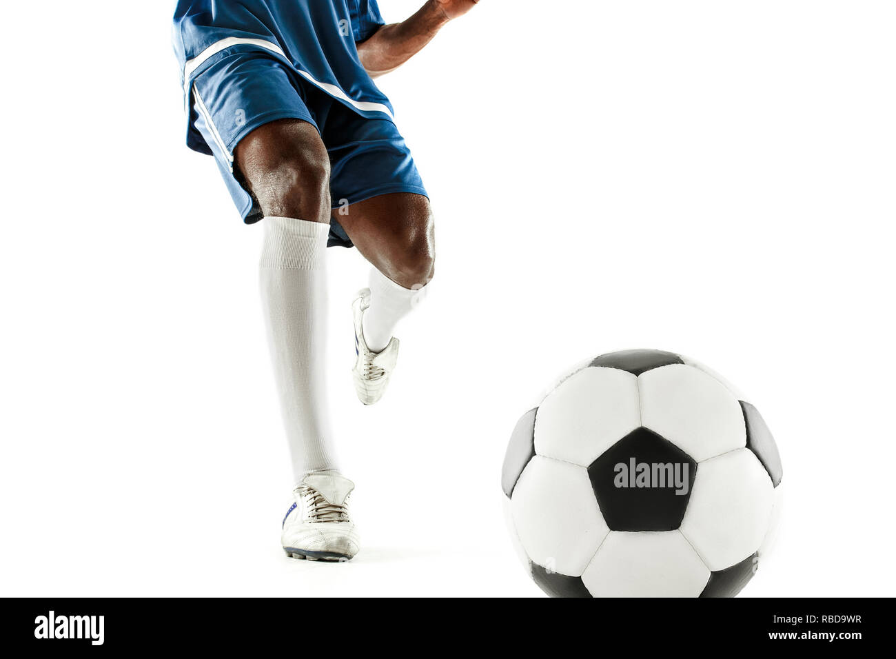 The legs of soccer player close-up isolated on white. African american ...