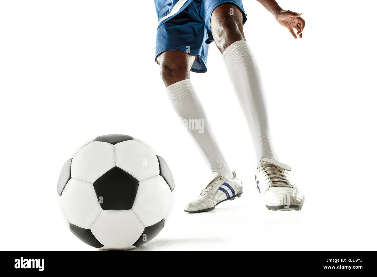 The legs of soccer player close-up isolated on white. African american ...