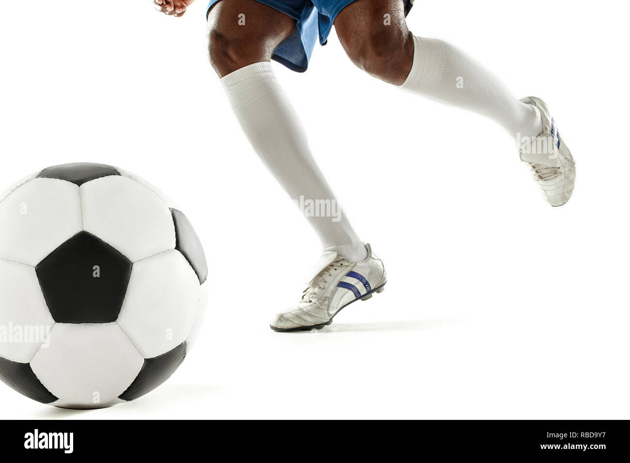 The legs of soccer player close-up isolated on white. African american ...