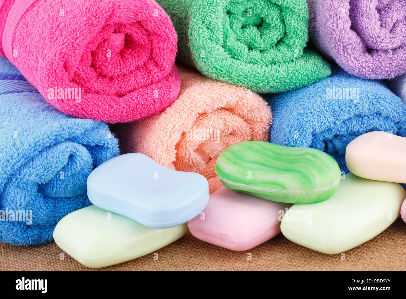 Colorful rolled towels with soaps closeup picture Stock Photo - Alamy