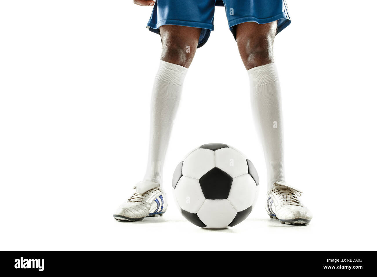 The legs of soccer player close-up isolated on white. African american ...