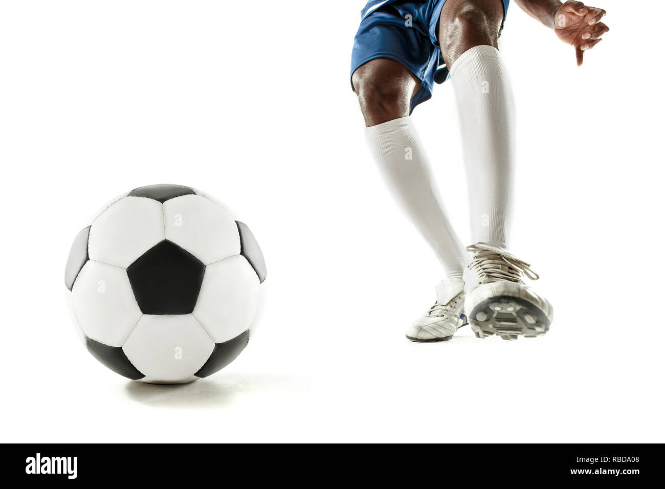The legs of soccer player close-up isolated on white. African american ...
