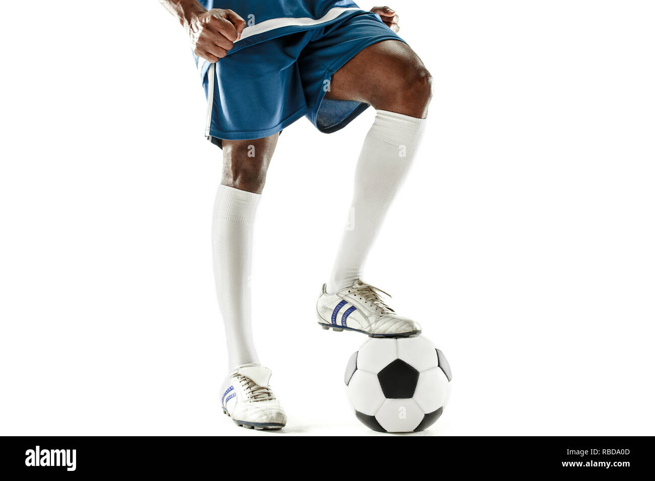 The legs of soccer player close-up isolated on white. African american ...
