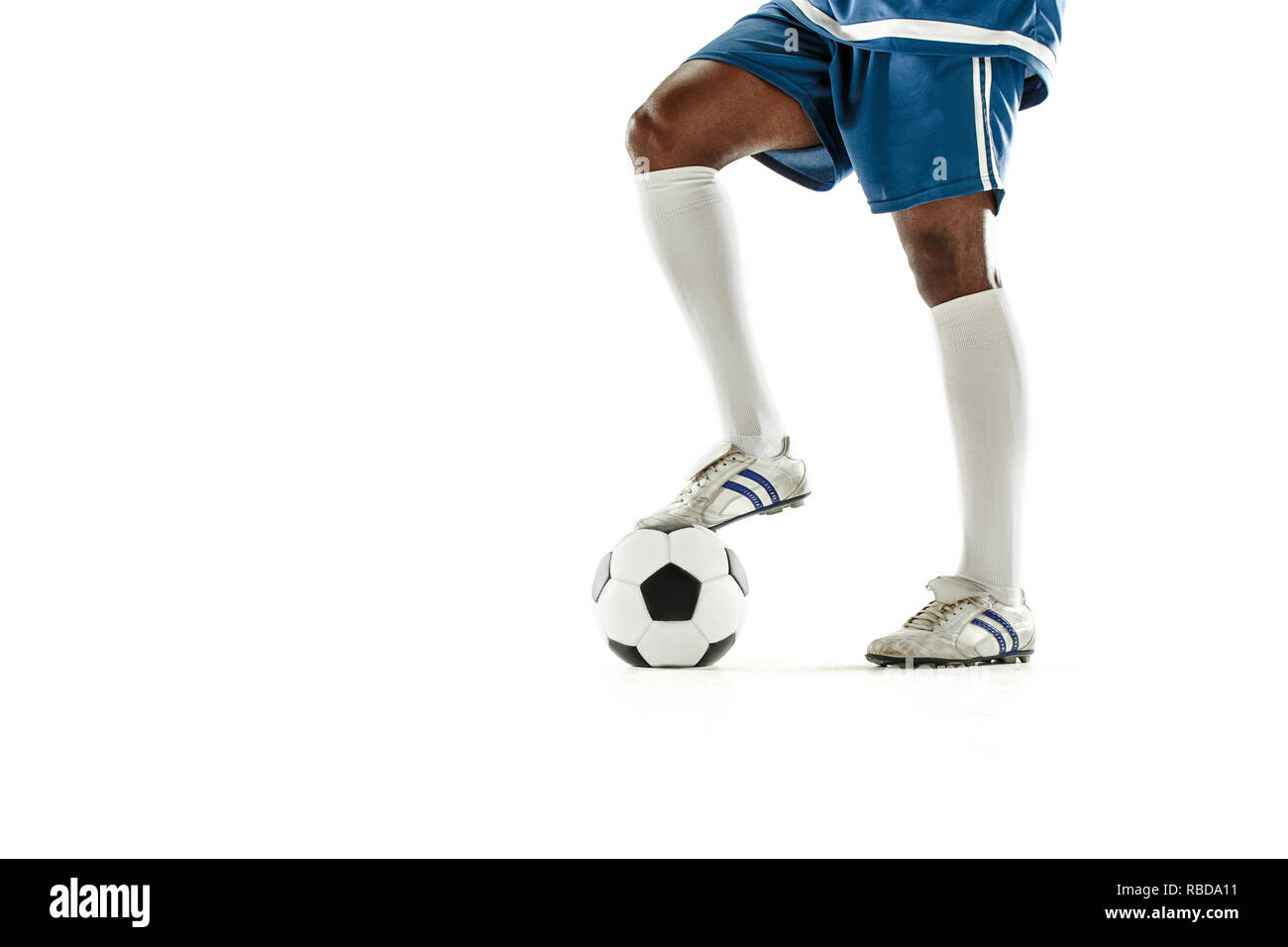 The legs of soccer player close-up isolated on white. African american ...