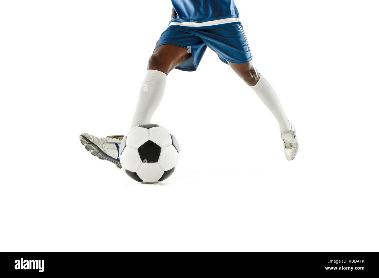 The legs of soccer player close-up isolated on white. African american ...