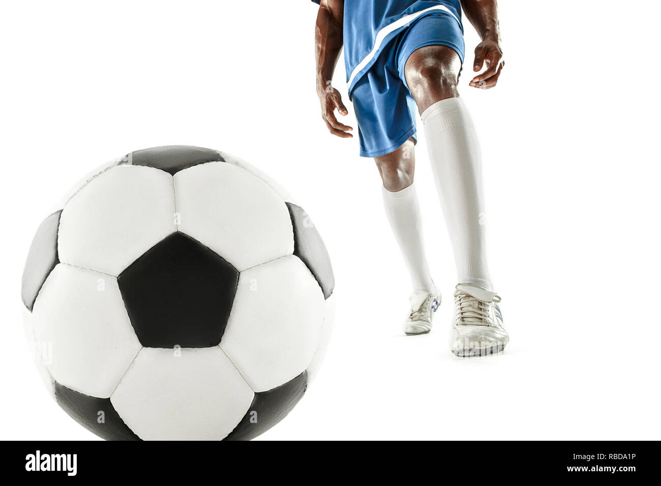 The legs of soccer player close-up isolated on white. African american ...