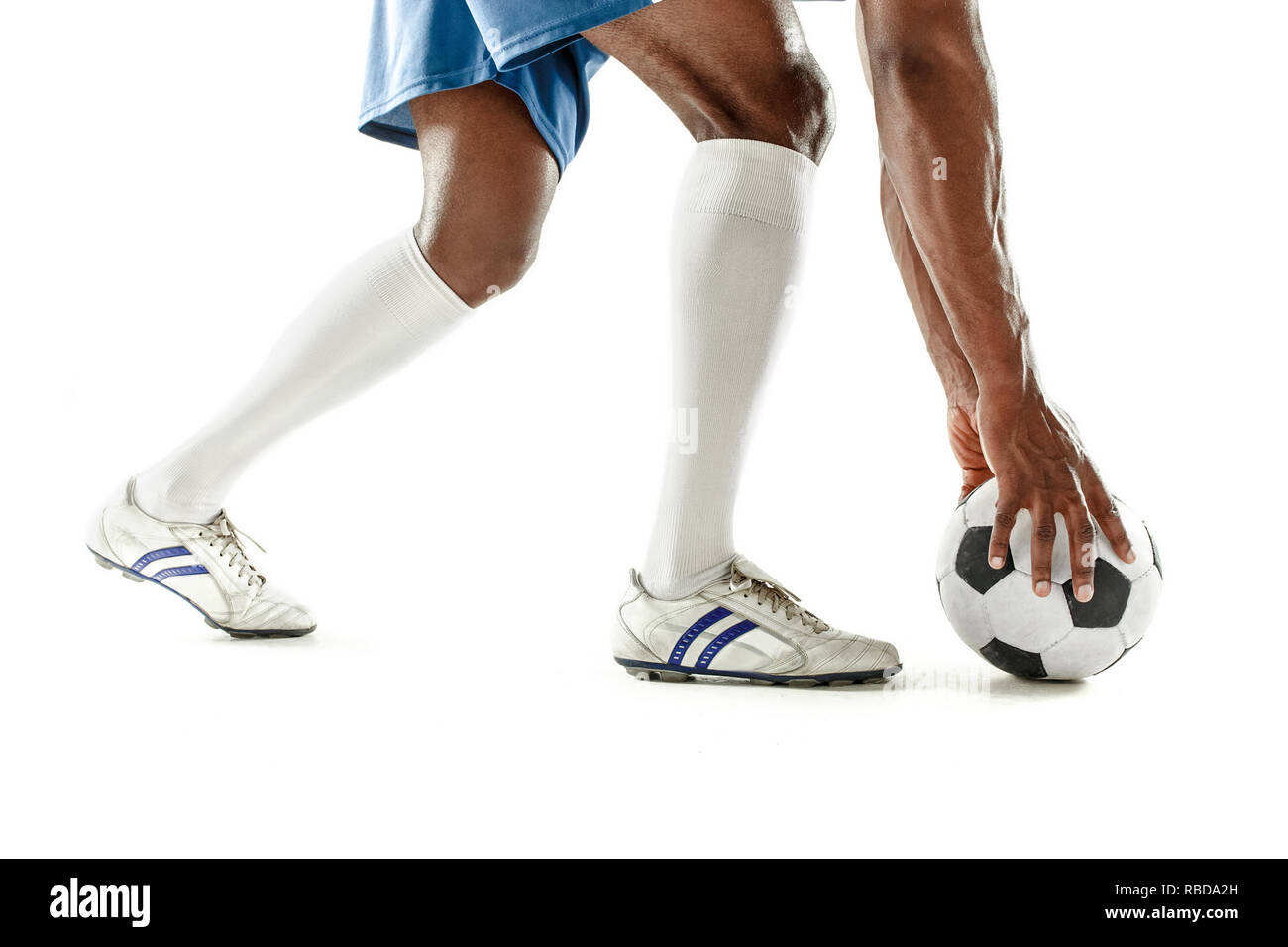 The legs of soccer player close-up isolated on white. African american ...