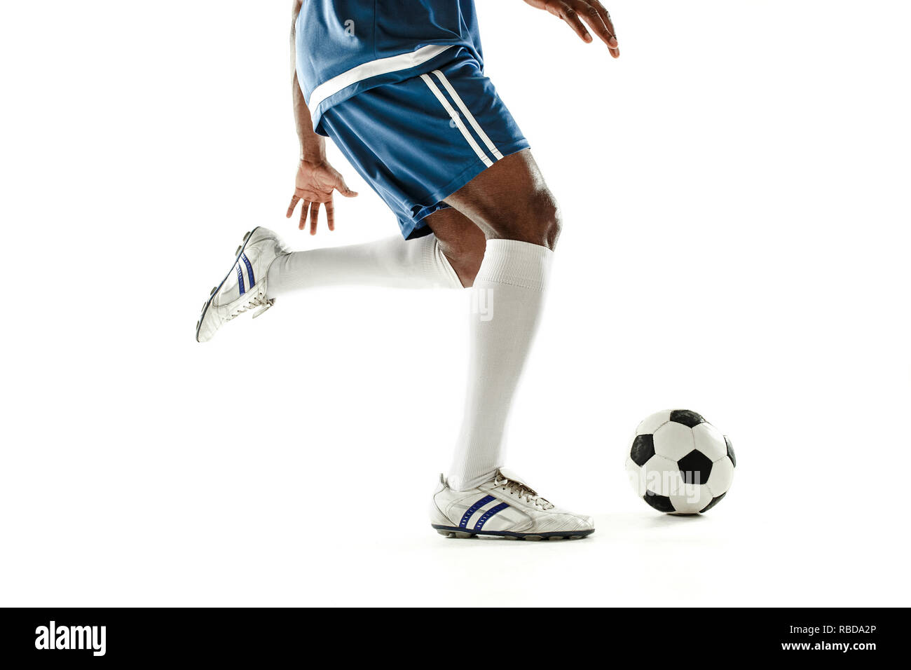 The legs of soccer player close-up isolated on white. African american ...