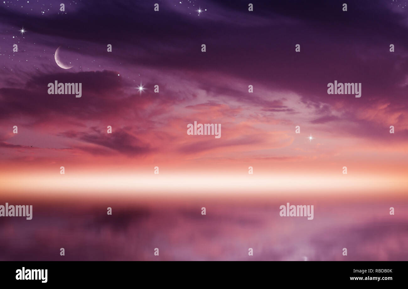 Amazing sunset picture with fluffy clouds, crescent moonagainst sun ...