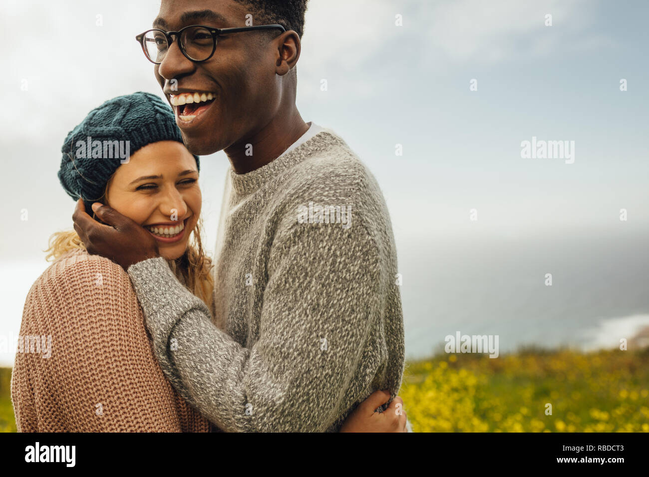 Loving interracial couple spending time together outdoors. Young man ...