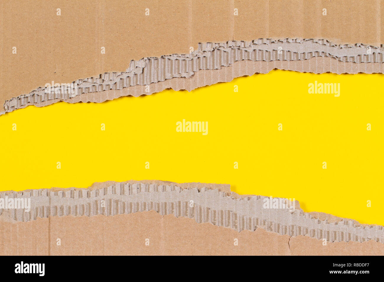 Brown corrugated cardboard ragged edge frame on yellow background Stock ...