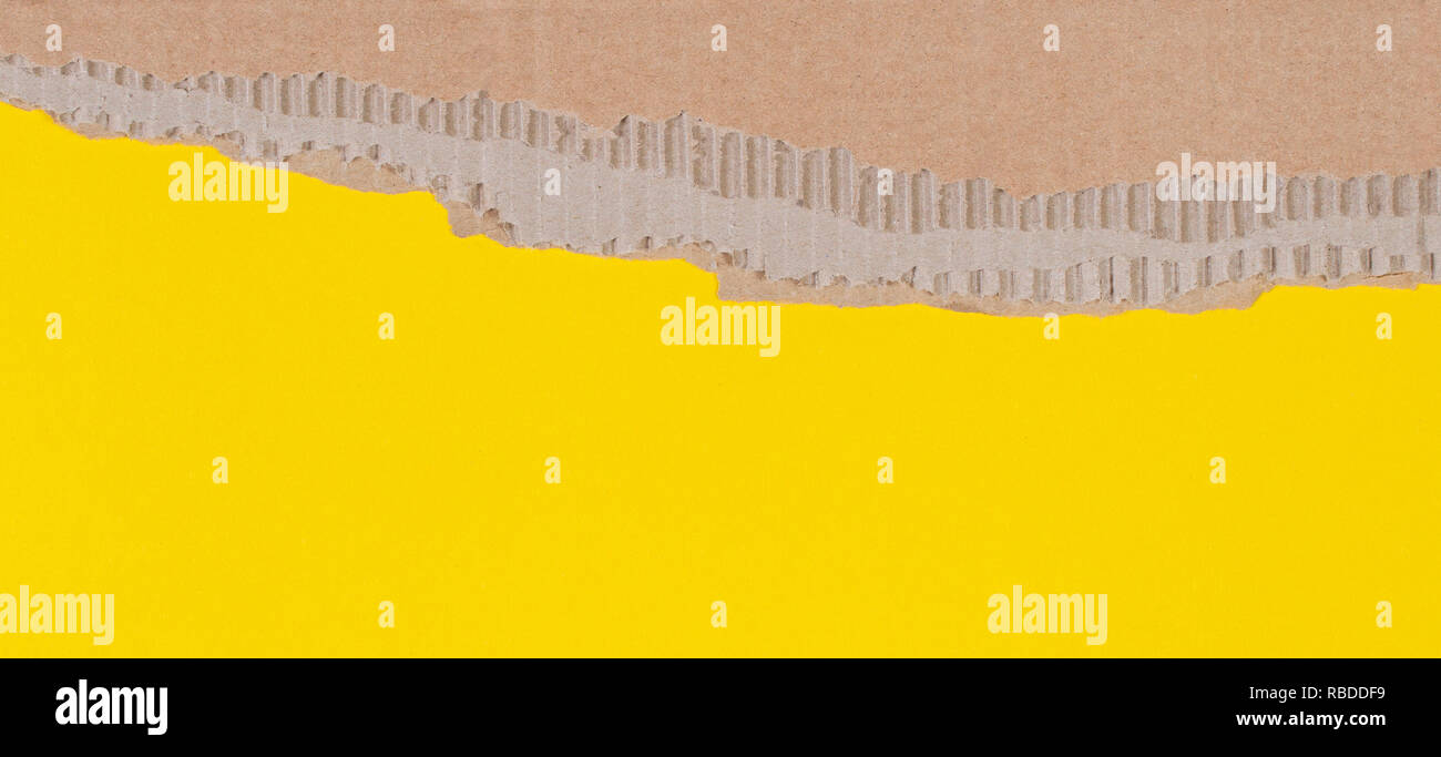 Brown corrugated cardboard ragged edge frame on yellow background Stock ...