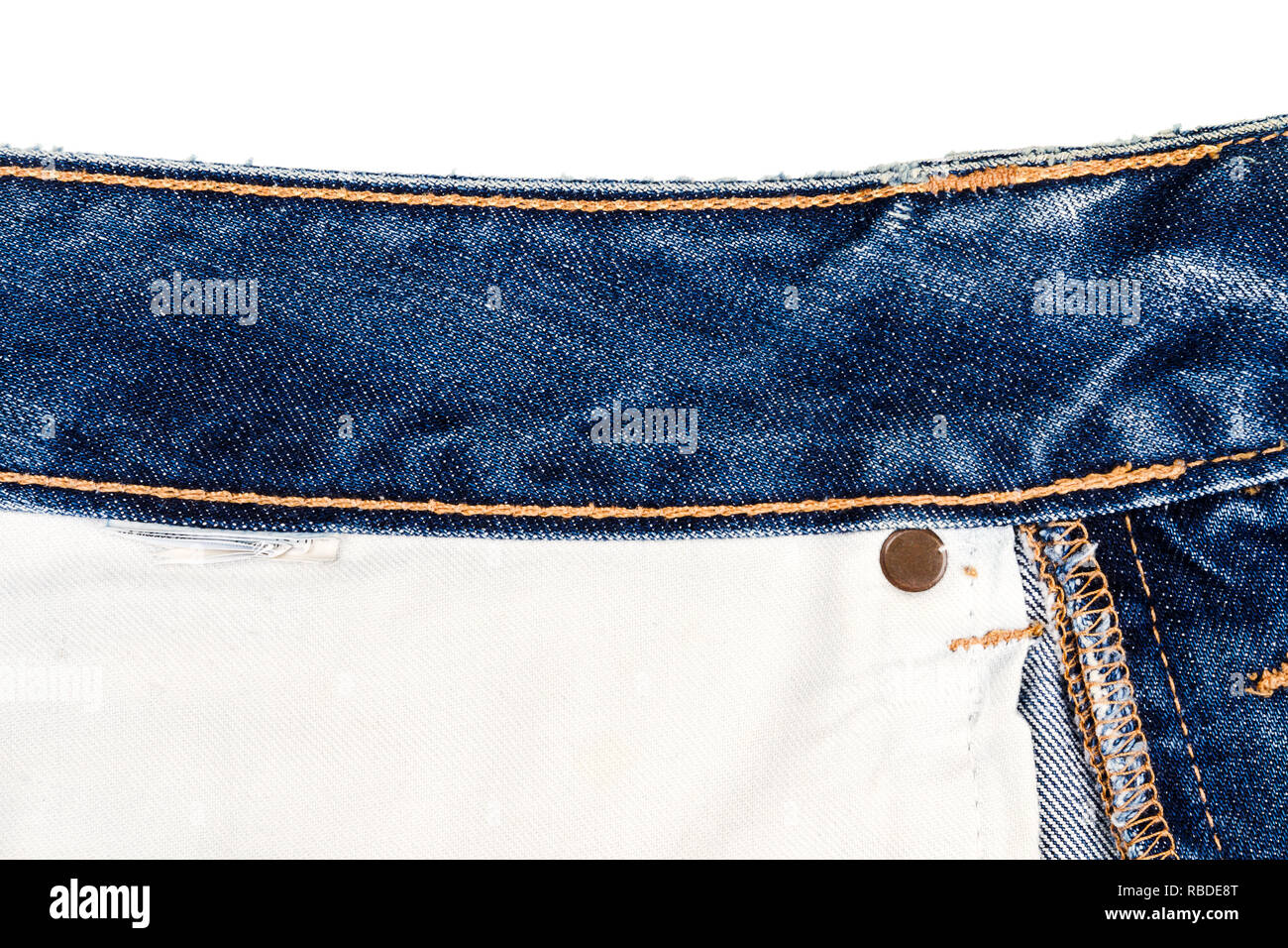 Piece of blue jeans fabric isolated on white background. Rough uneven ...