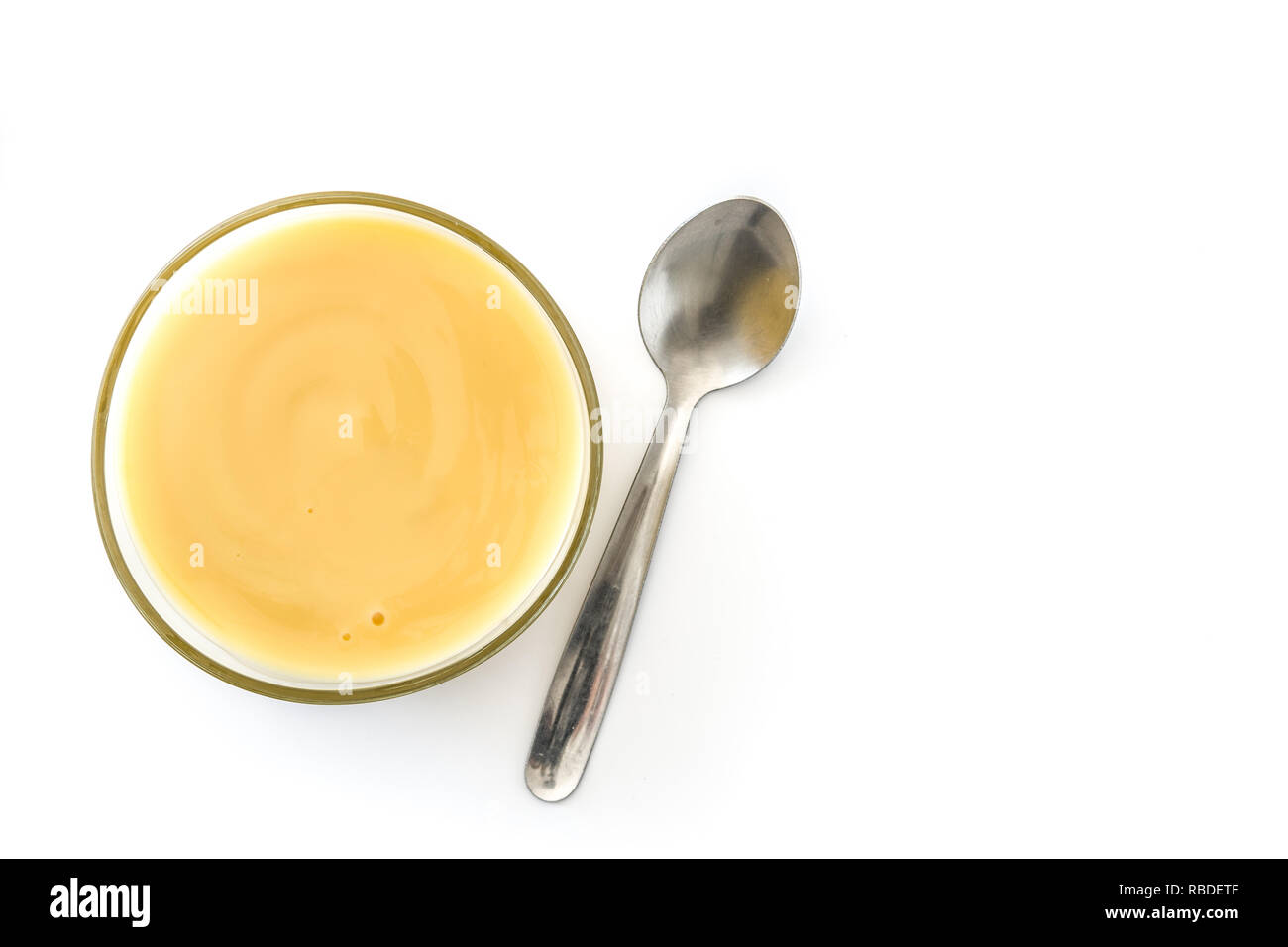 Bowl of homemade vanilla custard isolated on white background. Top view ...