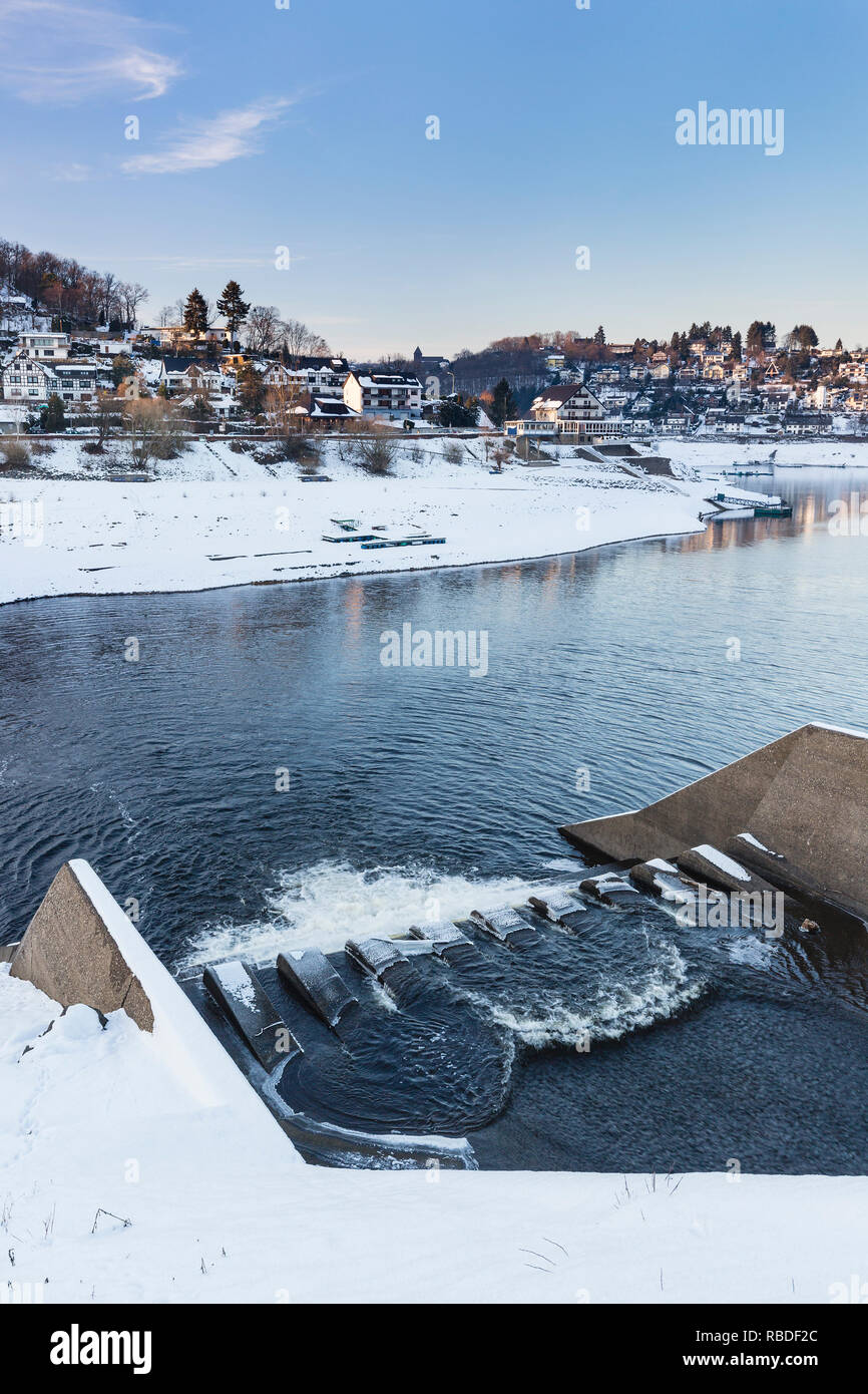 Evening view over lake Rursee to the village of Rurberg with snow in ...
