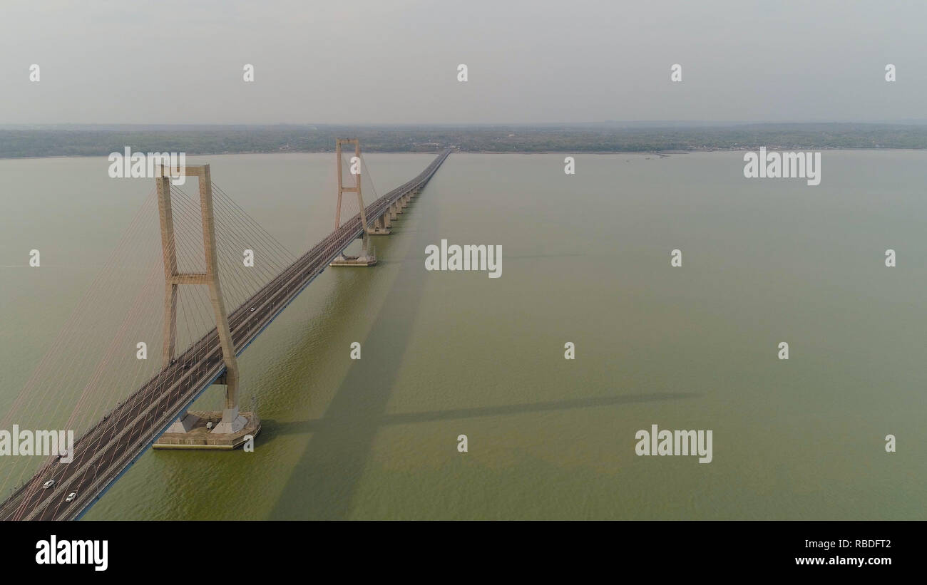 suspension bridge over madura strait with highway and car, surabaya ...