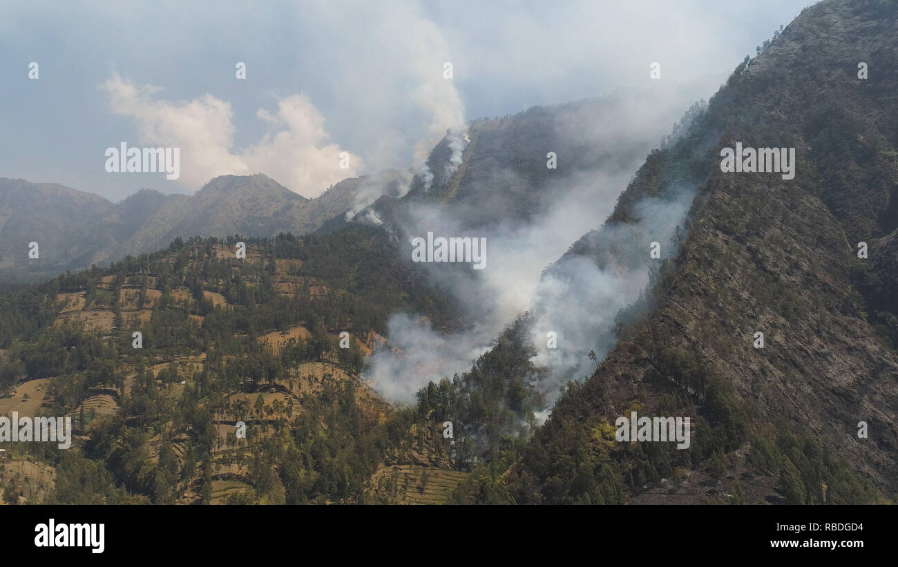 fire in mountain forest. aerial view forest fire and smoke on slopes ...