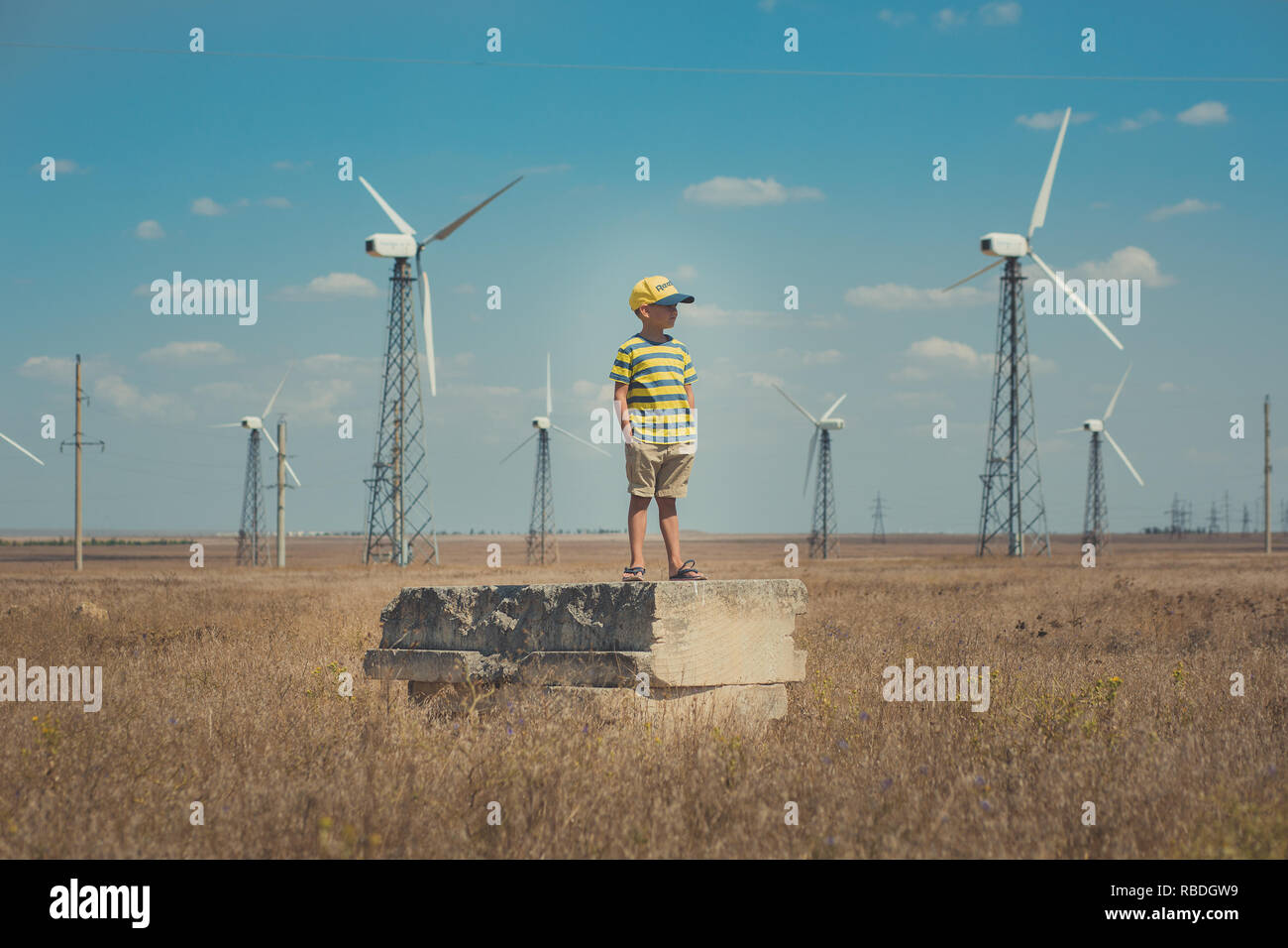 Cute boy and wind blowers during summer time Stock Photo - Alamy