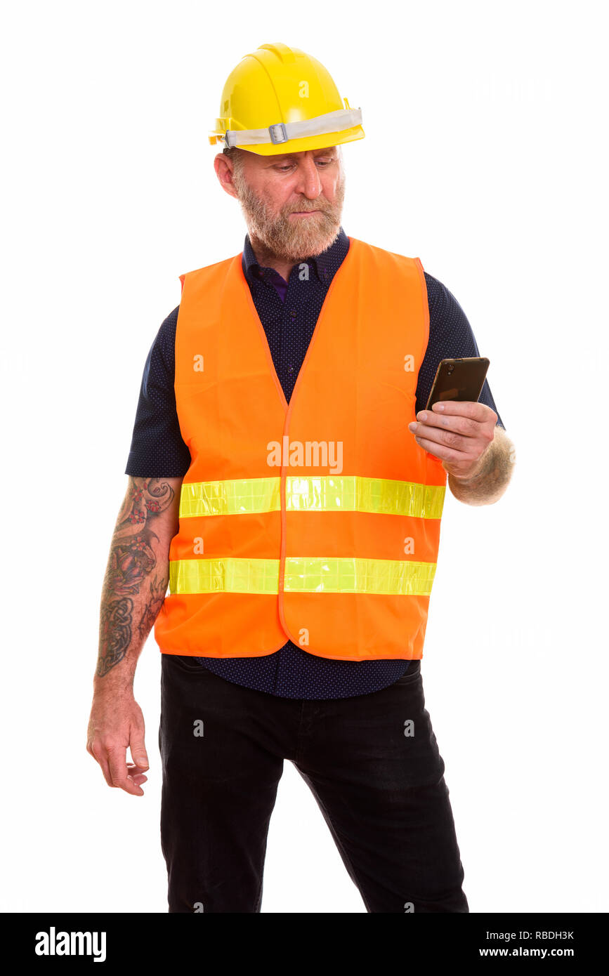 Mature bearded man construction worker using mobile phone Stock Photo ...