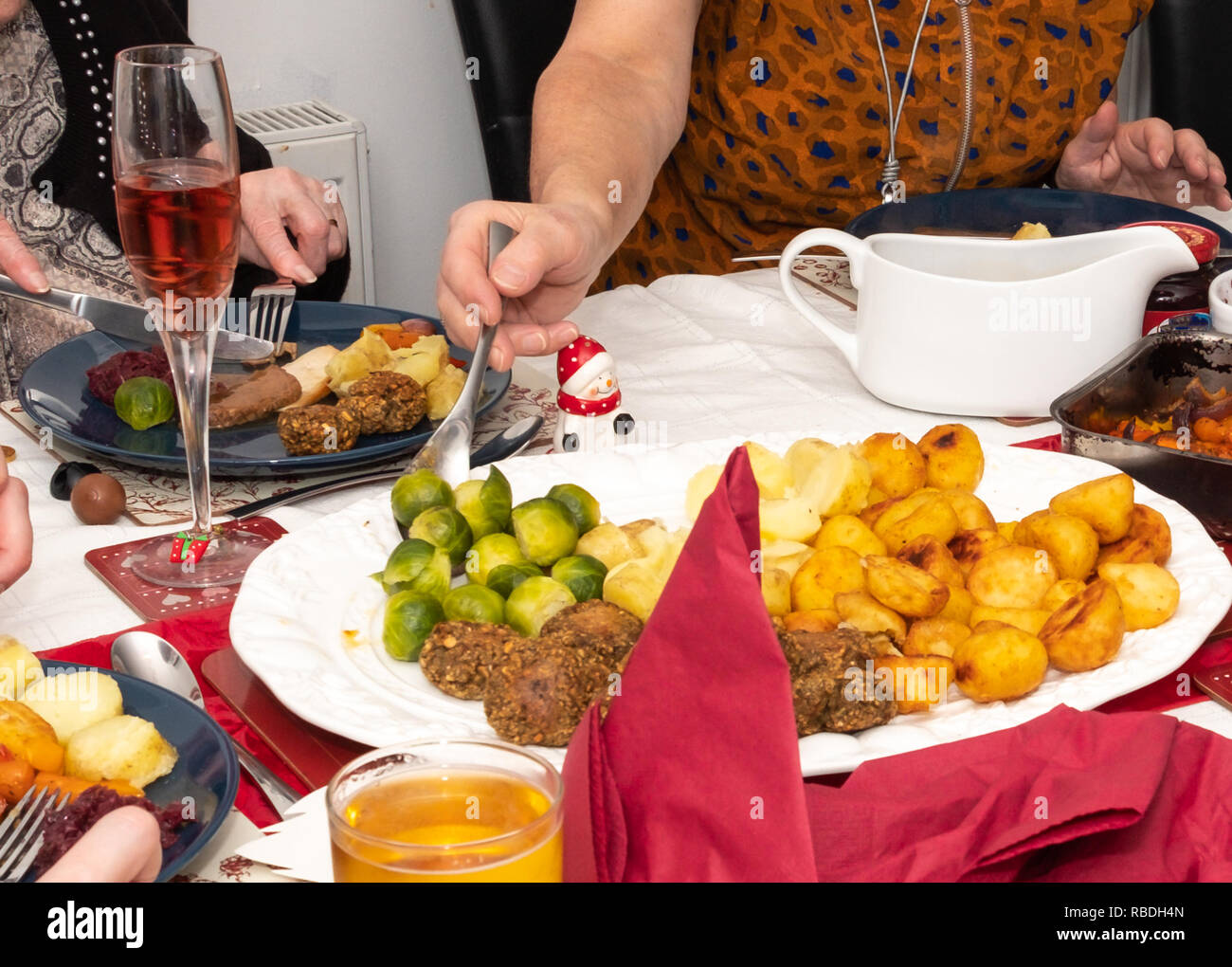 A very busy Christmas Table with all the family digging in Stock Photo ...