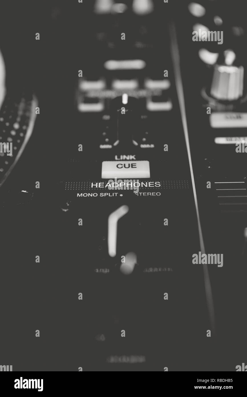 An artistic close up of a DJ's mixer / mix desk in black and white ...