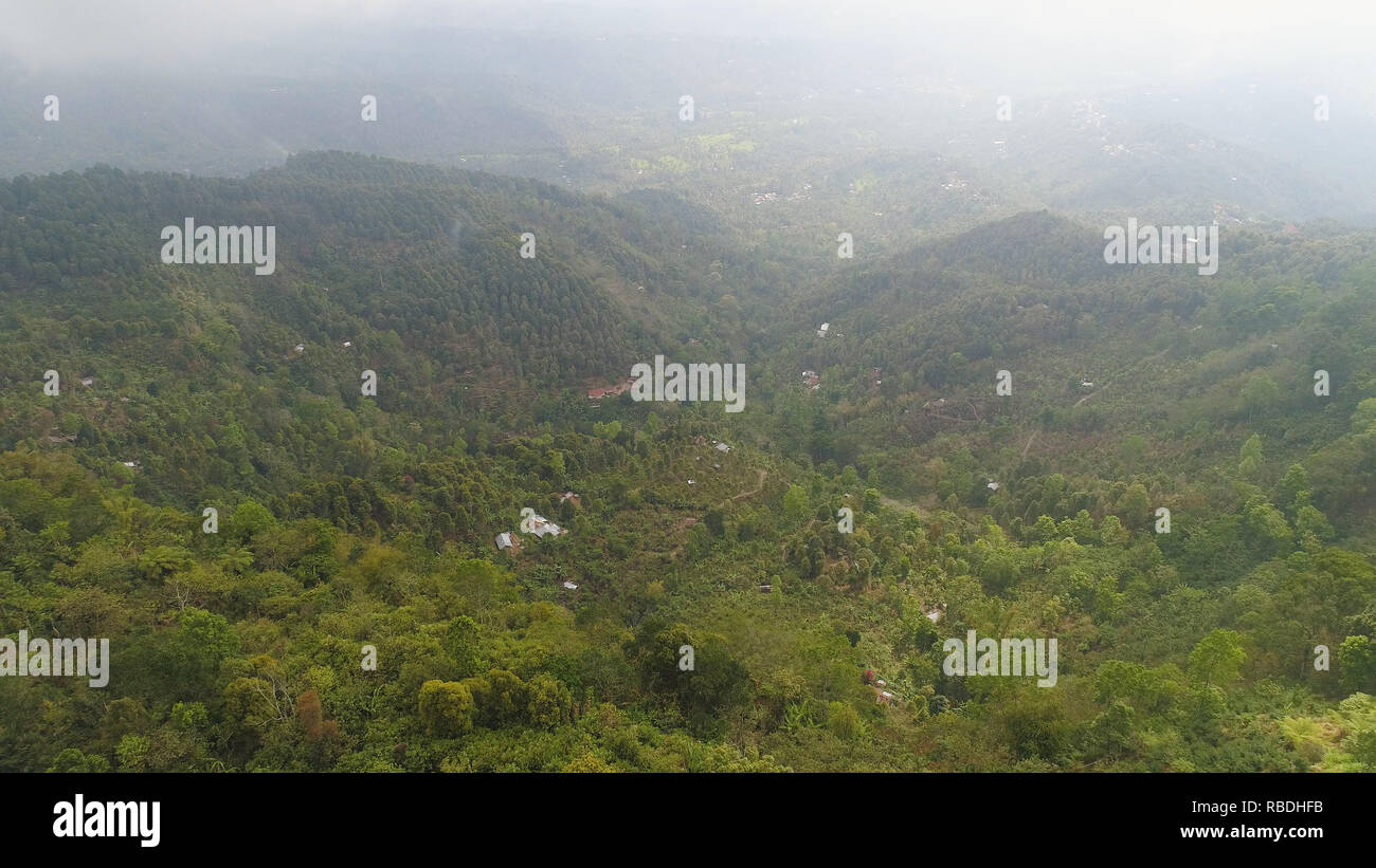 rural landscape mountains with farmlands, village, fields with crops ...