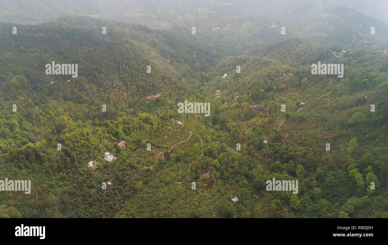 rural landscape mountains with farmlands, village, fields with crops ...