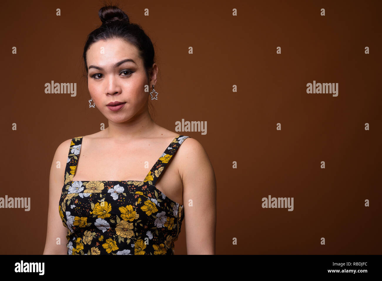 Young beautiful Asian transgender woman against brown background Stock ...