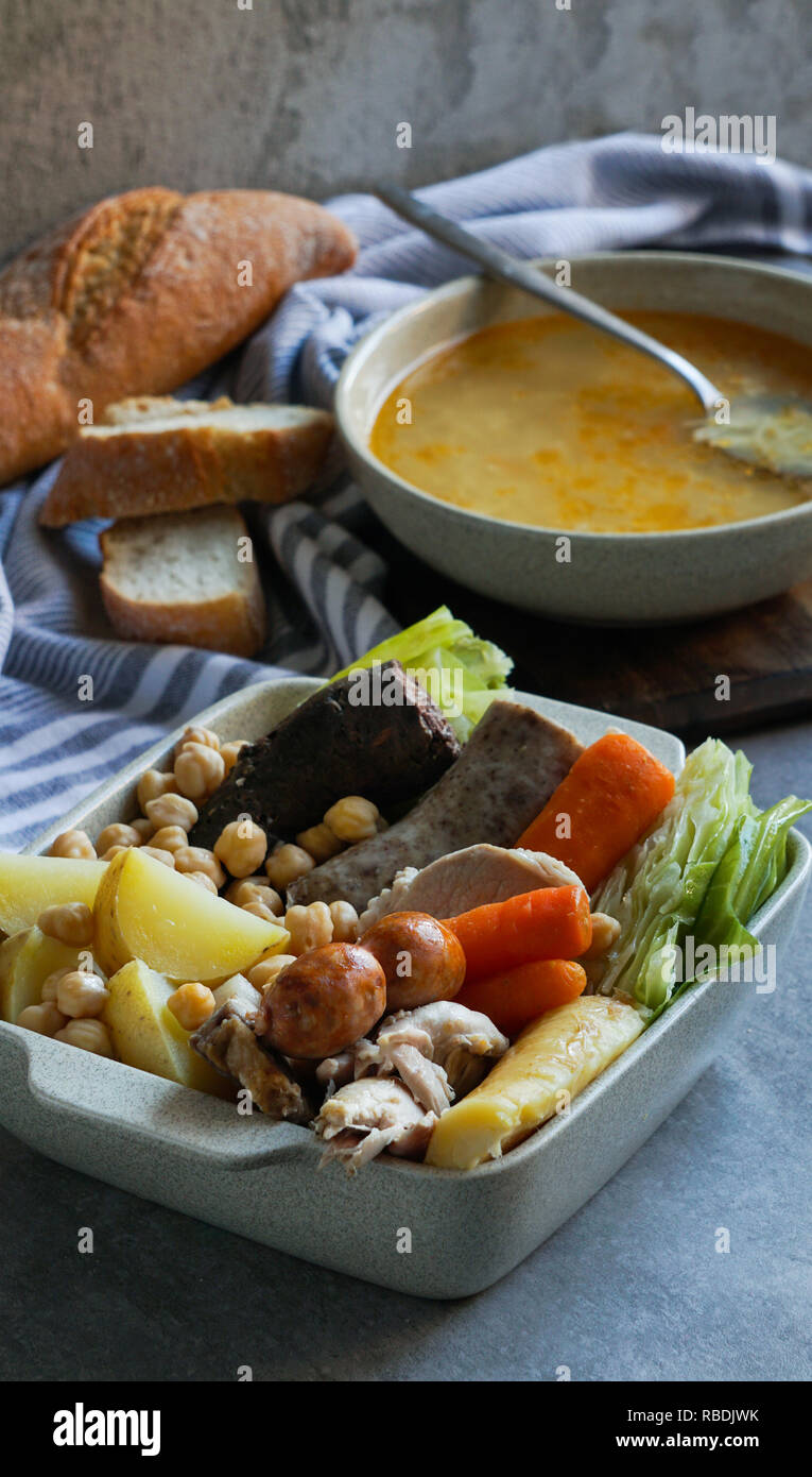 Cocido, traditional chickpea-based stew from Madrid. on the grey stone ...