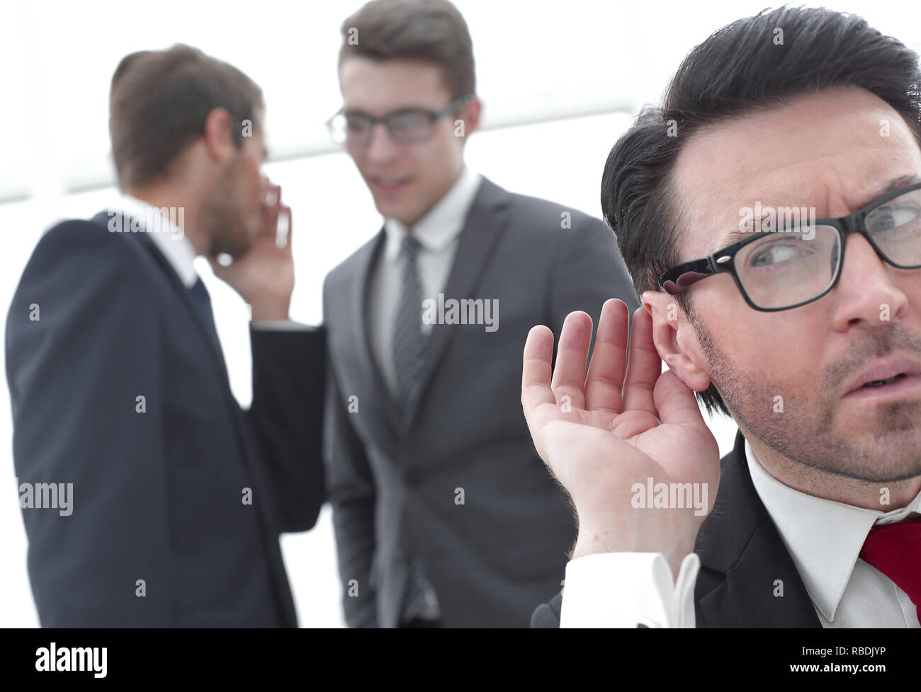 close up.businessman eavesdropping on conversation between colleagues ...