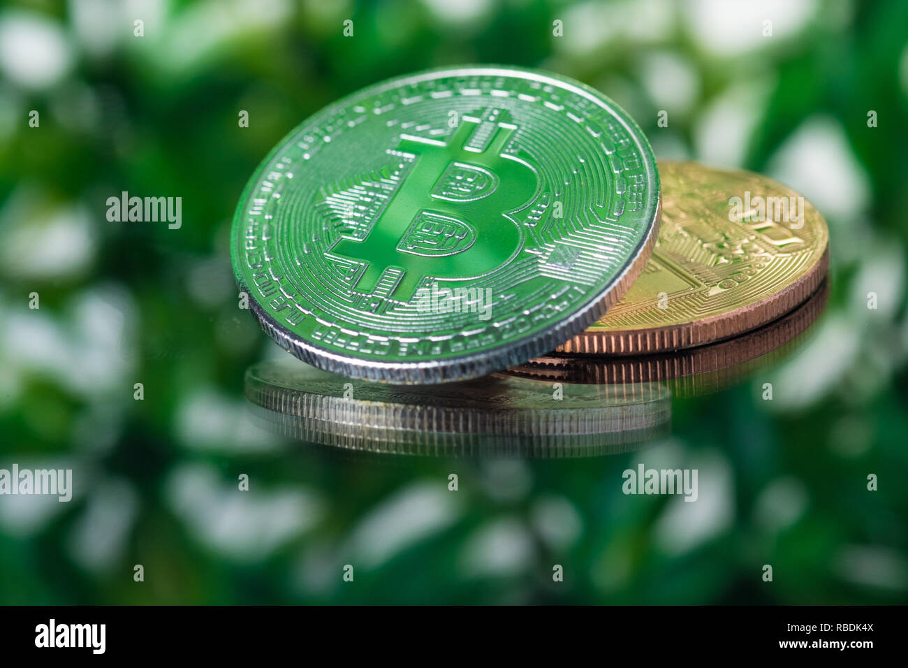 Bitcoin digital currency, bit-coin on green blurred bokeh background ...