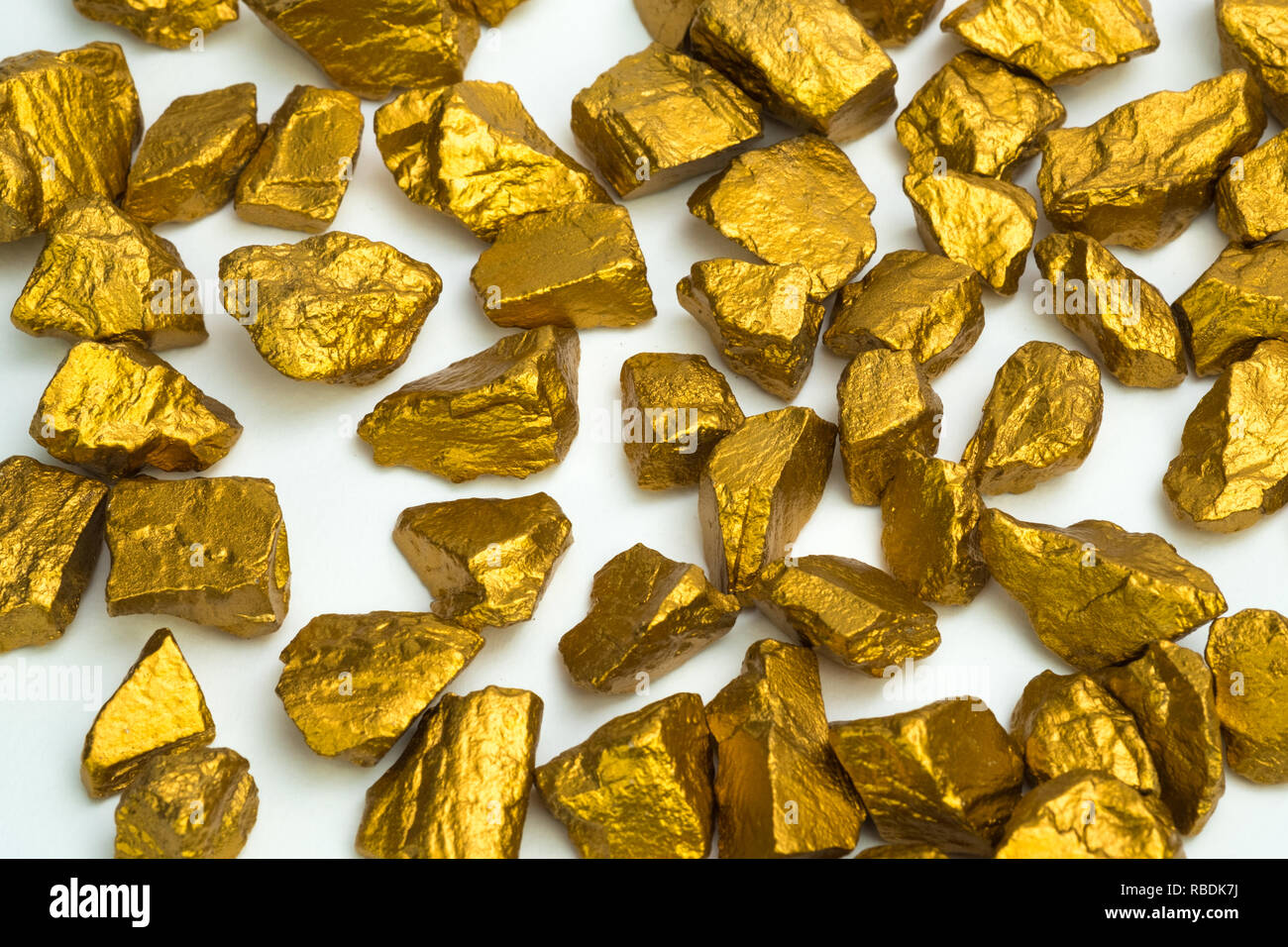 A pile of gold nuggets or gold ore on white background, precious stone ...