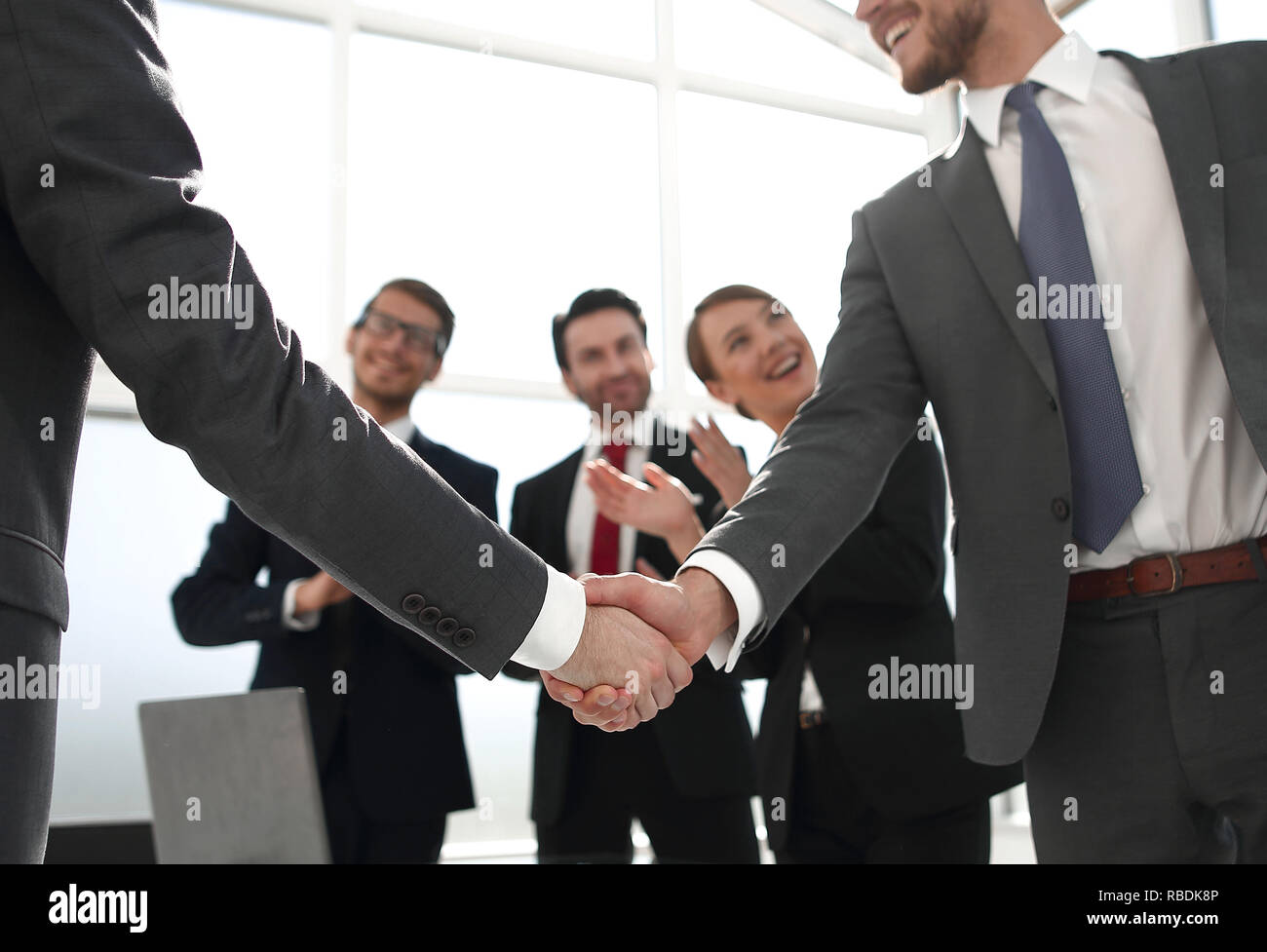 business handshake of business partners after signing the contract ...