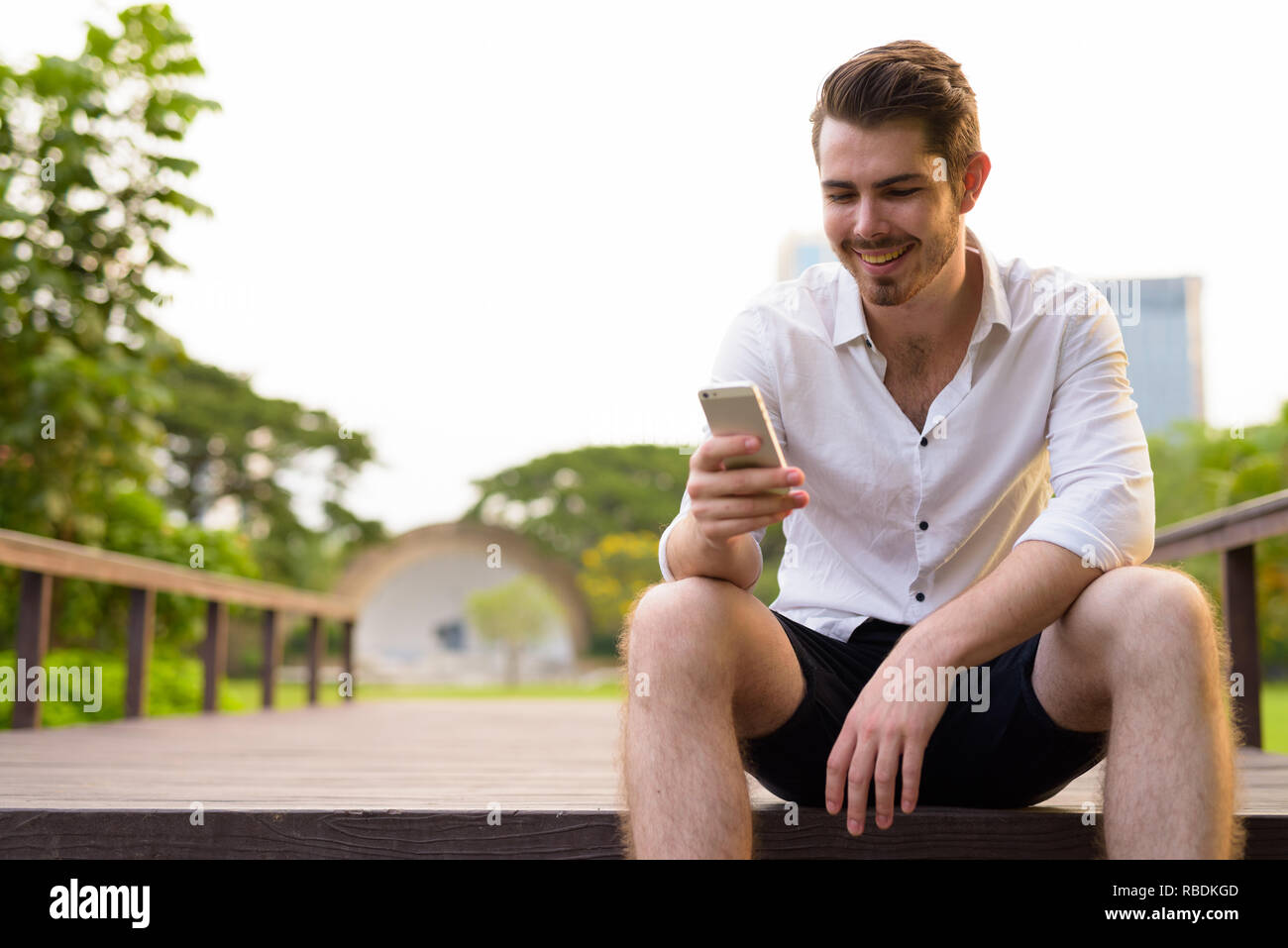 Happy young men sitting hi-res stock photography and images - Alamy