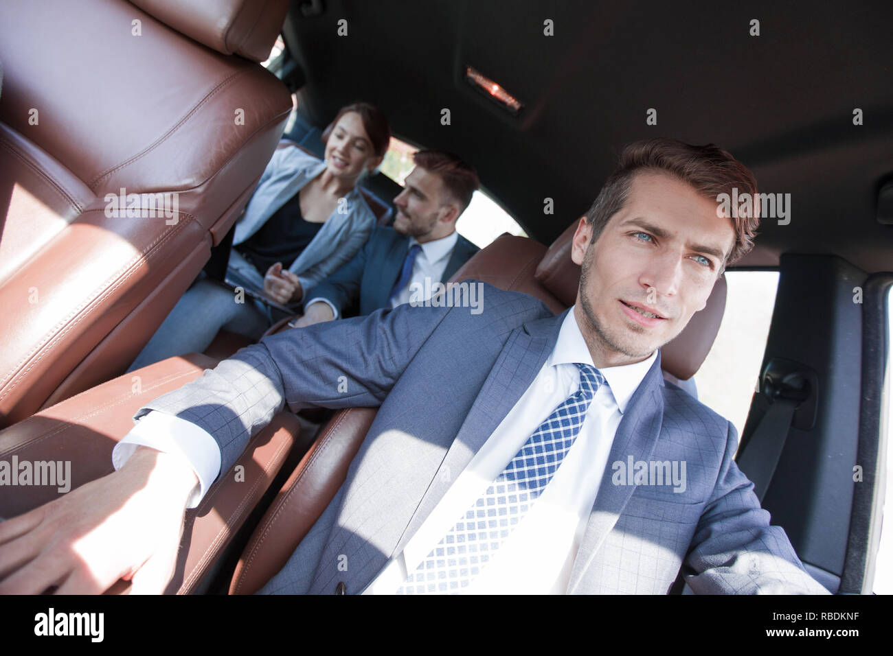 group of business people in a luxury car Stock Photo - Alamy