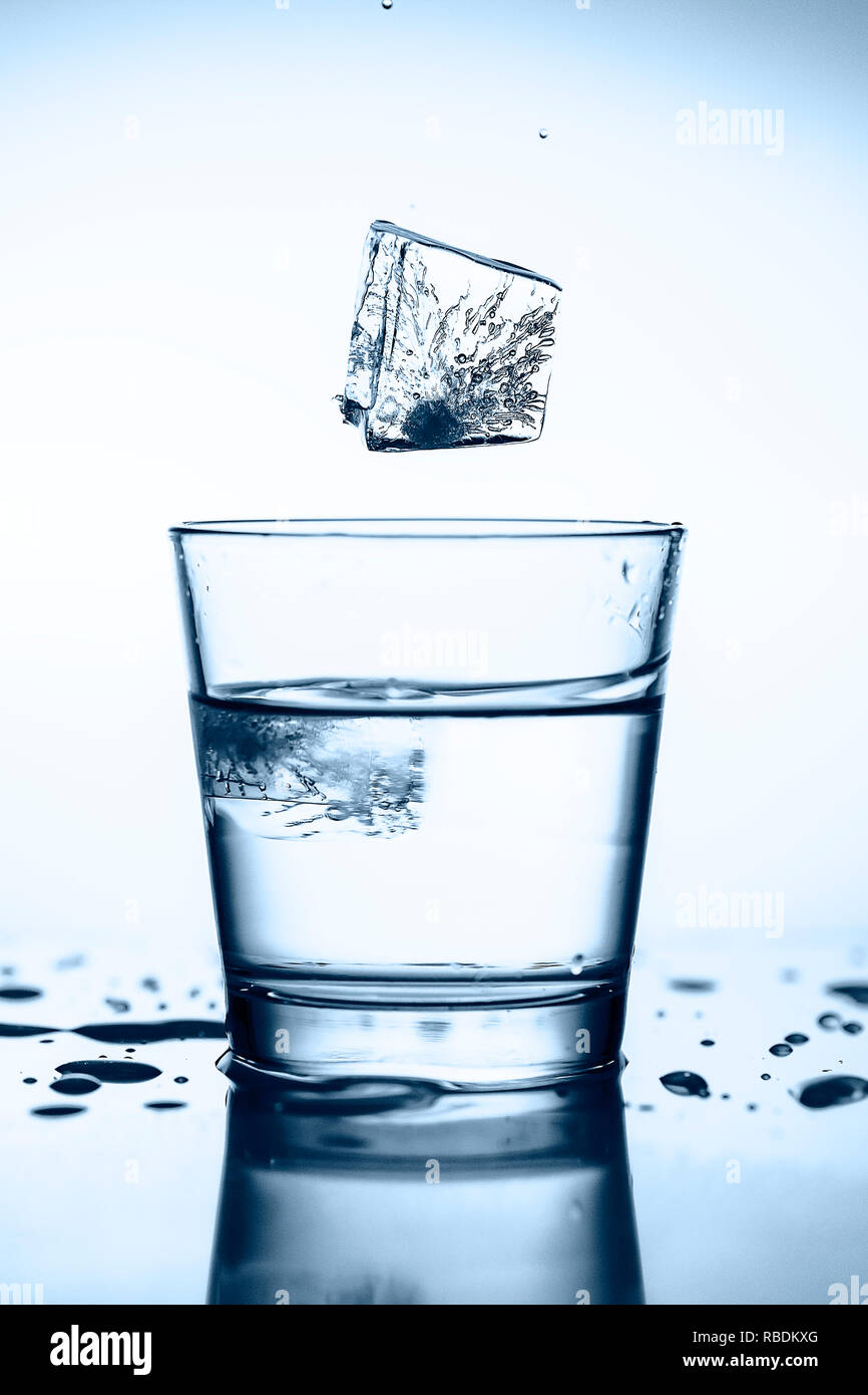 Splash ice cubes in a water glass Stock Photo - Alamy