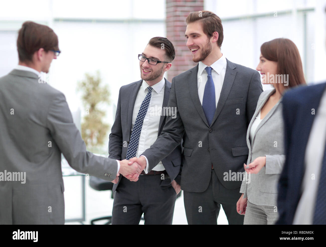 Confident young people, handshake and smile Stock Photo - Alamy